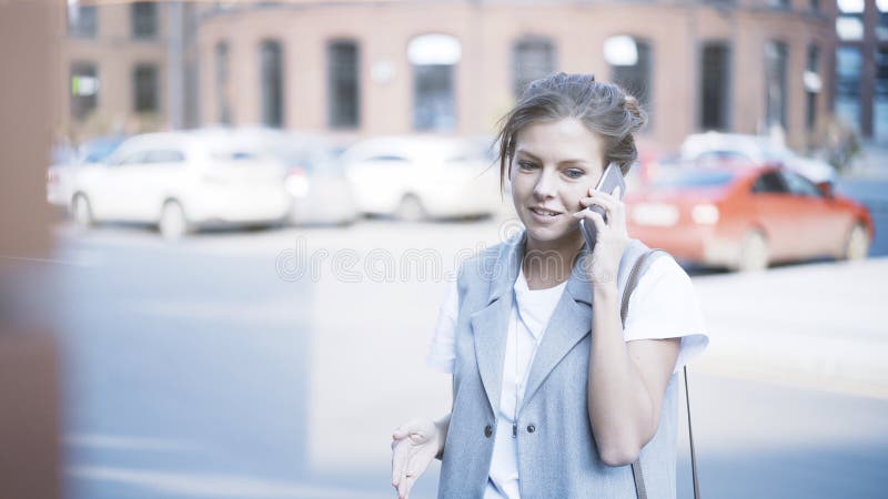 A Young Smiling Pretty Girl is Having a Call Outside Outdoors Stock ...