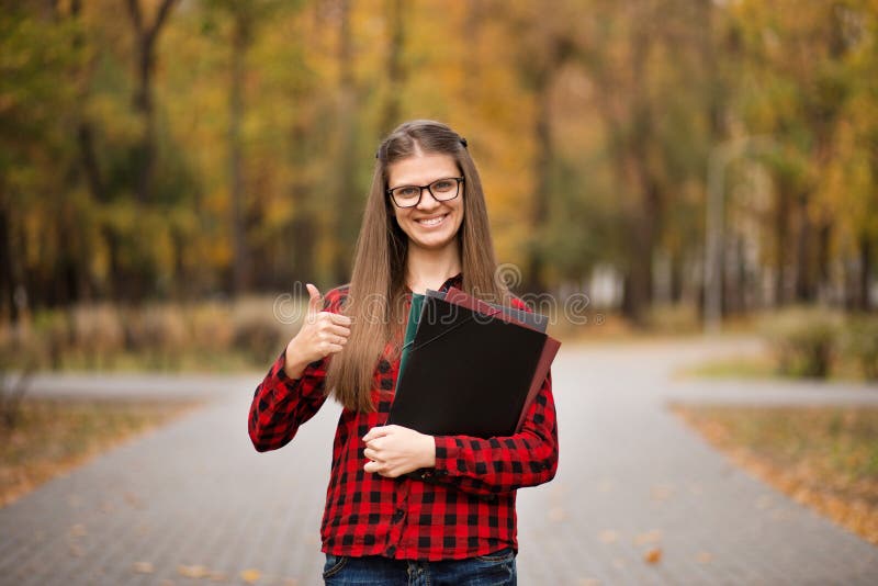 Young Smiling Student Woman with Folders. Knowledge Concept Stock Photo ... Young Smiling Student Woman with Folders. Knowledge Concept Stock Photo ...