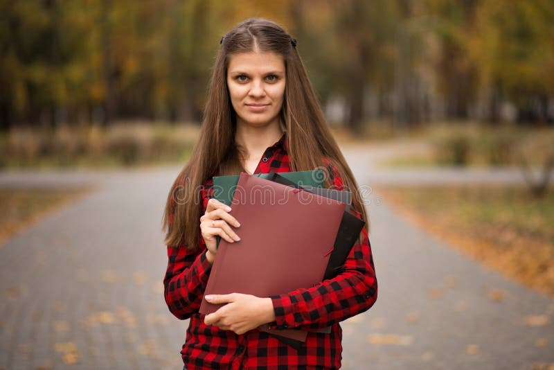 Young Smiling Student Woman with Folders. Education Concept Stock Photo ... Young Smiling Student Woman with Folders. Education Concept Stock Photo ...