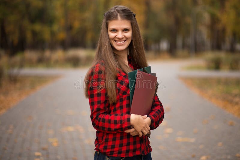 Young Smiling Student Woman with Folders. Education Concept Stock Photo ... Young Smiling Student Woman with Folders. Education Concept Stock Photo ...