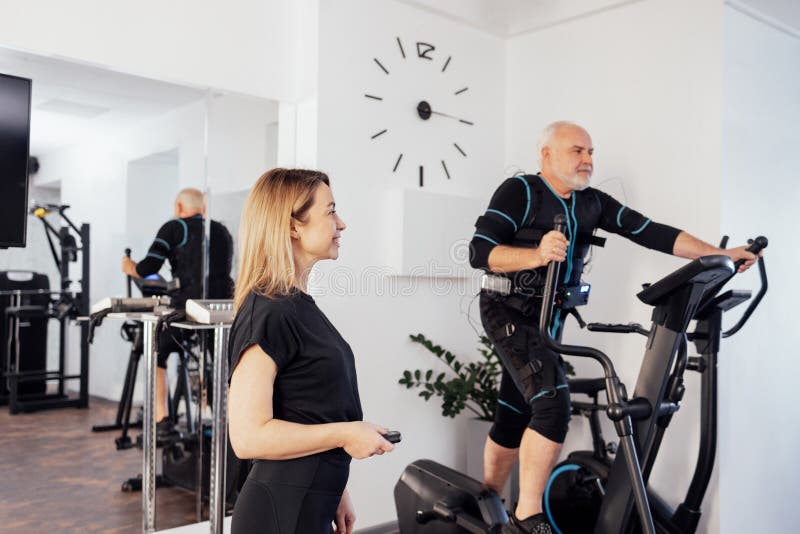 Young Smiling Trainer is Doing Electrical Muscle Stimulation Workout ...