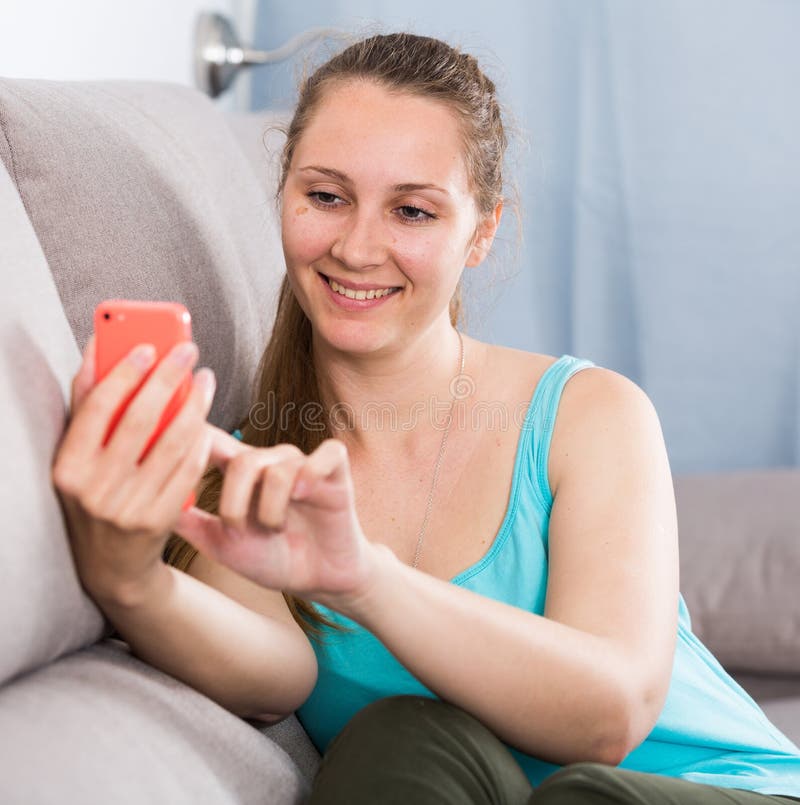 Woman using phone stock photo. Image of sofa, lying - 264951682