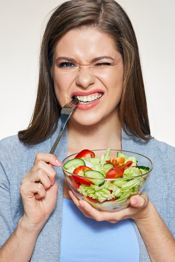 Young Smiling Woman Holding Glass Bowl With Vegetable Salad Stock