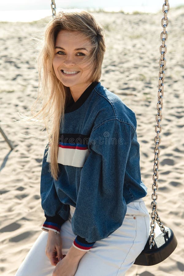 Young Smiling Woman Sitting on the Swing at the Sandy Beach. Stock ...