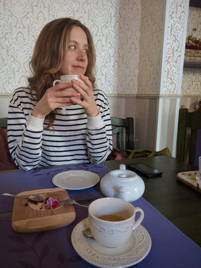 Young Smiling Woman with Tea Cup in Hand. Cafe Stock Photo - Image of ...