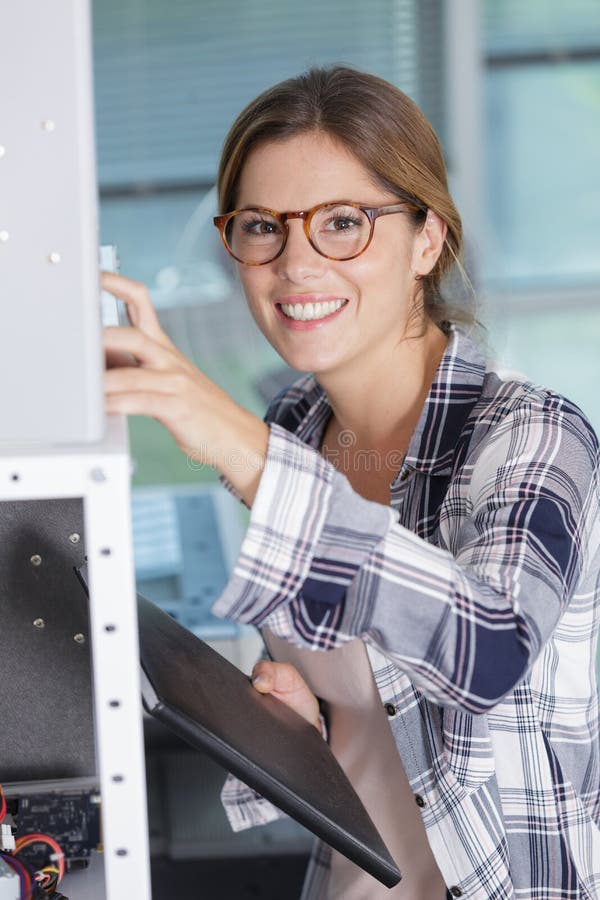 Young Smiling Woman Technician Looking at Camera Stock Photo - Image of ...