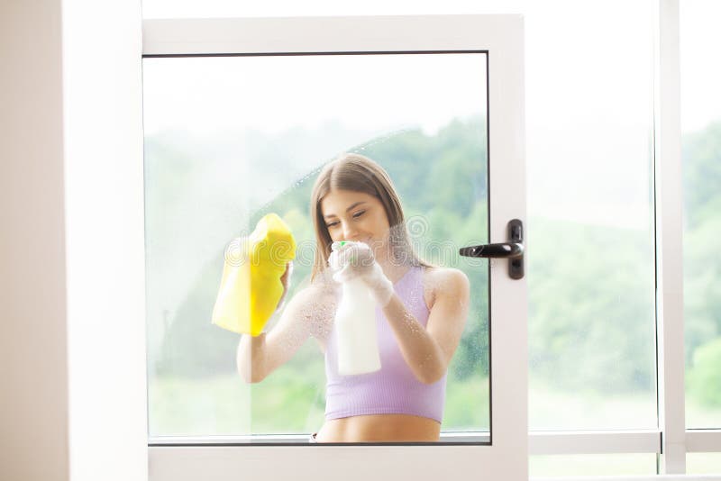Young Smiling Woman Washing Window with Sponge Stock Image - Image of ...