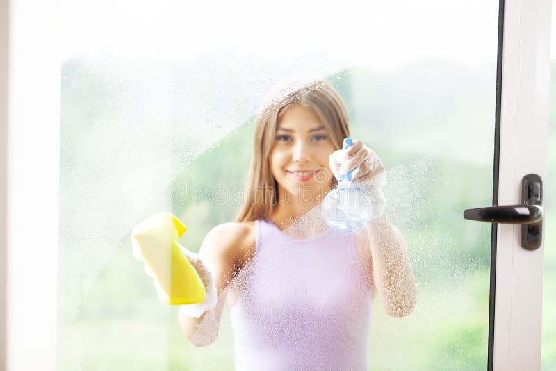 Young Smiling Woman Washing Window with Sponge. Stock Image - Image of ...