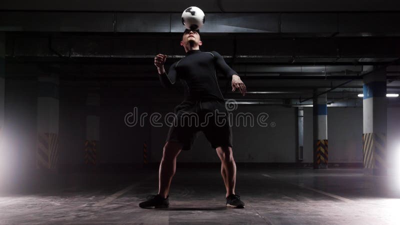 A Young Soccer Man Training the Basic Tricks with the Ball Balancing ...
