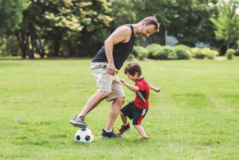 Young Soccer Player Having Fun on a Field with His Father Stock Photo ...