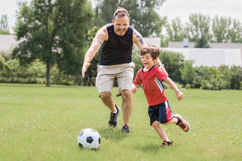 Young Soccer Player Having Fun on a Field with His Father Stock Image ...