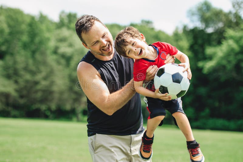 Young Soccer Player Having Fun on a Field with His Father Stock Photo ...