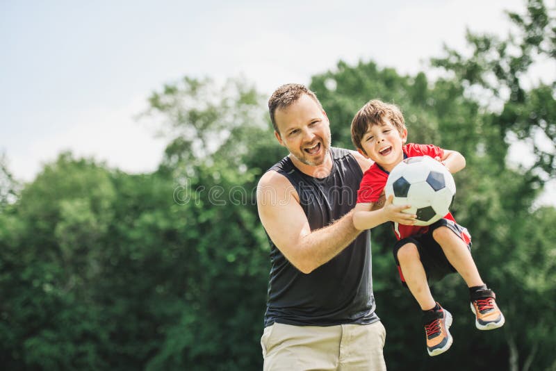 Young Soccer Player Having Fun on a Field with His Father Stock Photo ...