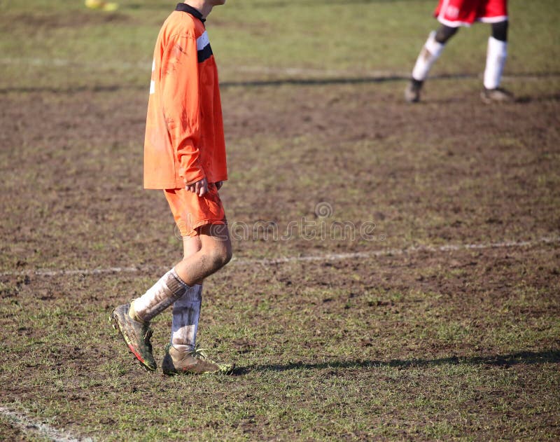 Young Soccer Player in the Mud Stock Image - Image of muddy, apparel ...