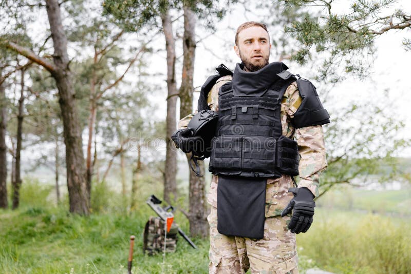 Young Soldier in Uniforms and Tactical Vest Works in the Forest and ...