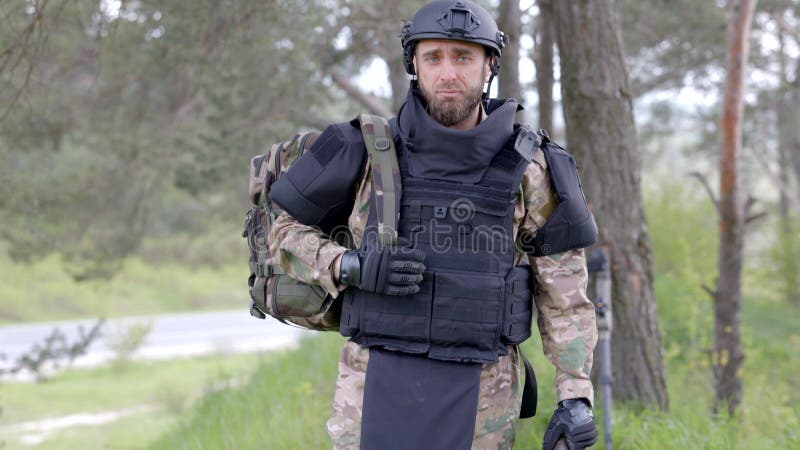 Young Soldier in Uniforms and Tactical Vest Works in the Forest and ...