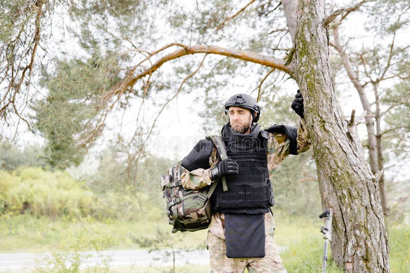Young Soldier in Uniforms and Tactical Vest Works in the Forest and ...