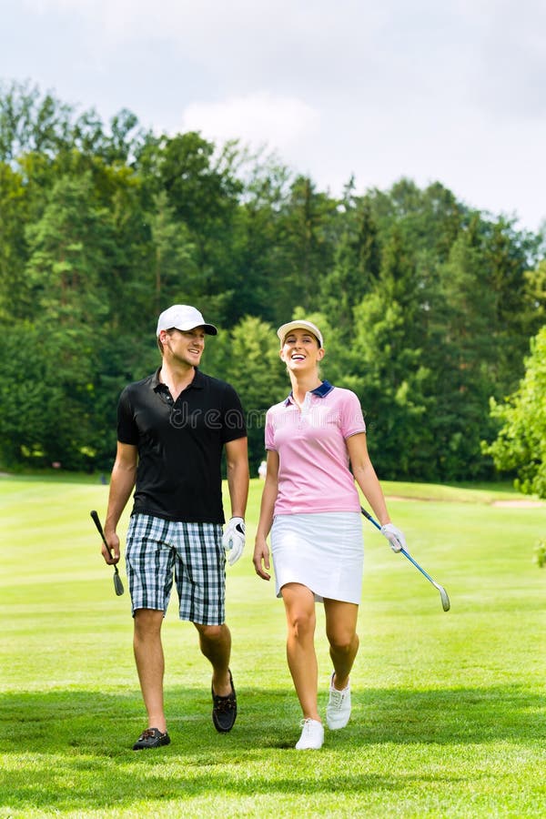 Young Sportive Couple Playing Golf on a Course Stock Image - Image of ...
