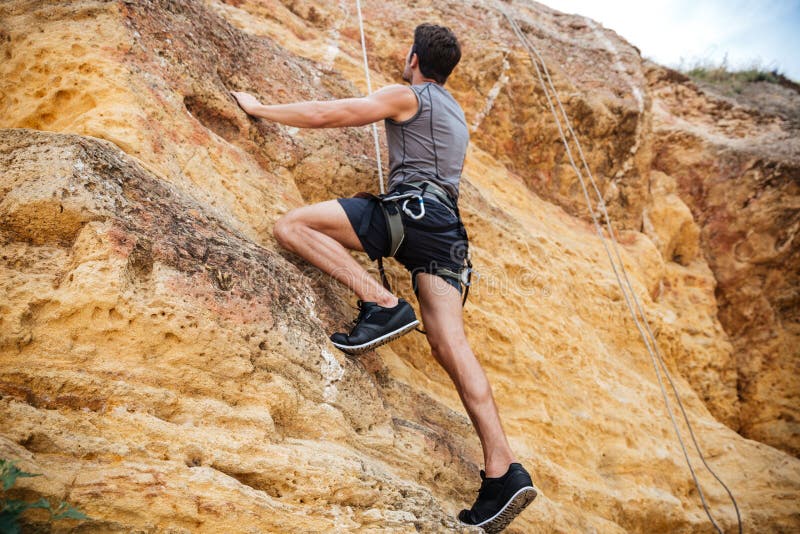 Climbing up a cliff stock image. Image of leisure, hike - 7922277