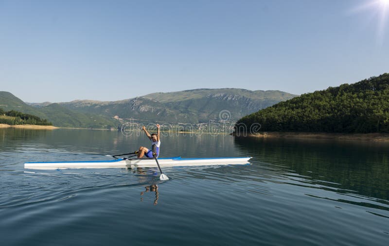 The Young Sportsman is Rowing on the Racing Kayak Stock Photo - Image ...