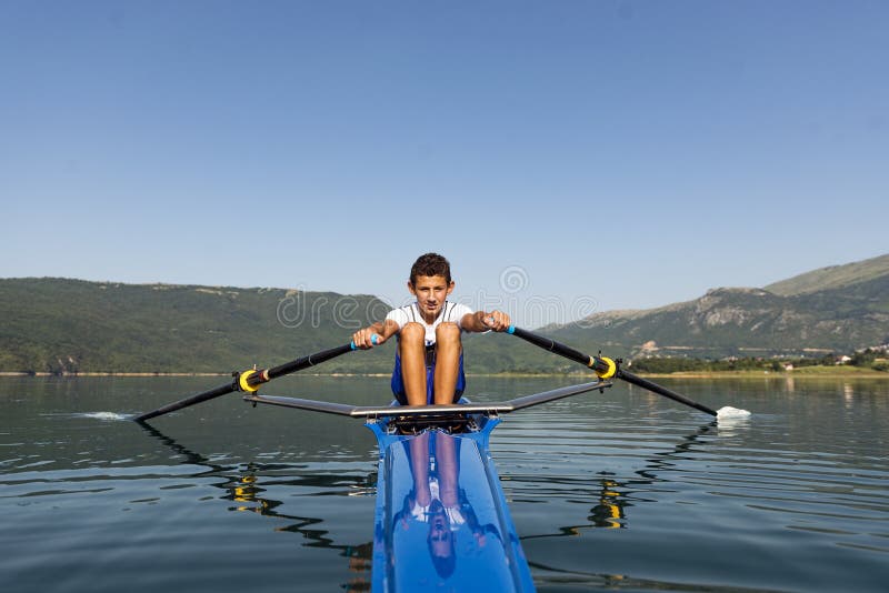 The Young Sportsman is Rowing on the Racing Kayak Stock Image - Image ...