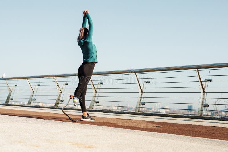 Young Sportswoman with Prosthesis Doing Exercise while Working Out ...