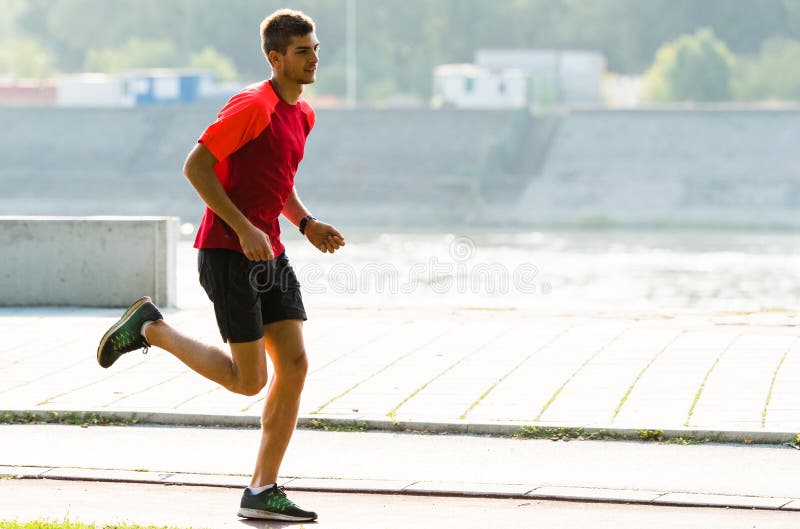 Young sporty man jogging stock photo. Image of person - 109589574