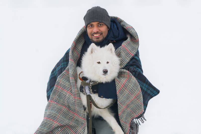 Young Sri Lankan Man Embracing Solid White Fluffy Dog in Winter ...