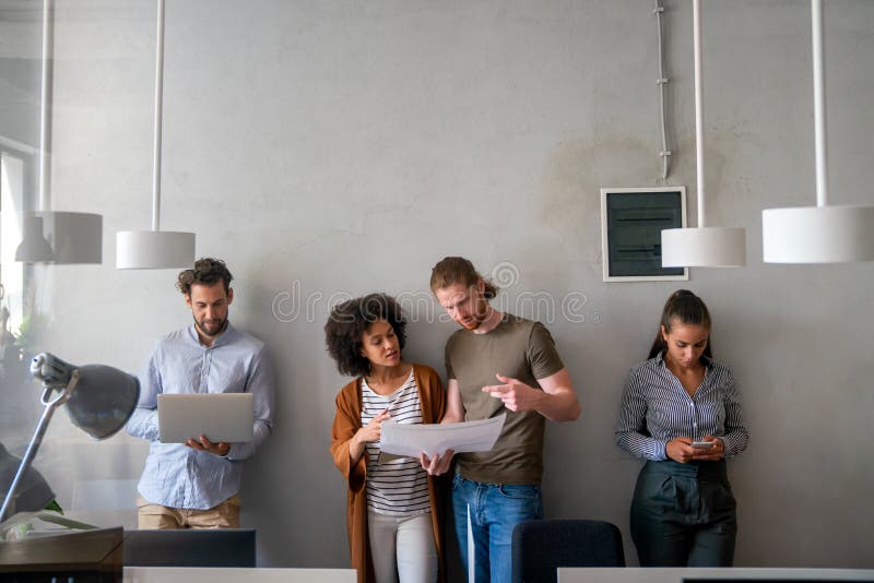 Young Startup Business People Having Fun, Working and Chatting at ...