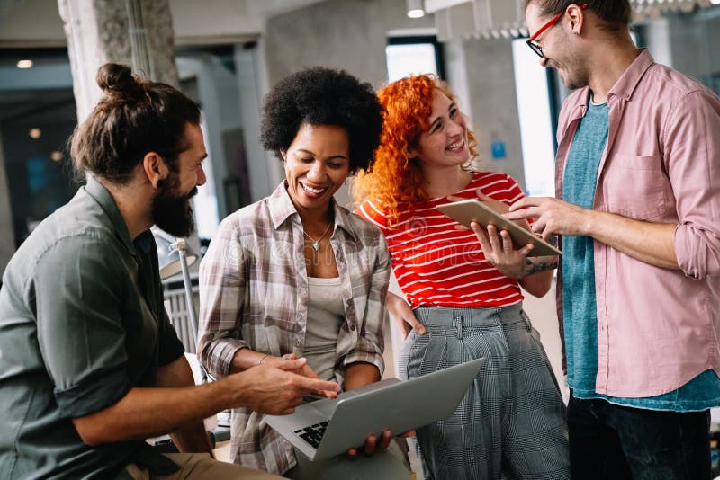 Young Startup Business People Having Fun, Working and Chatting at ...