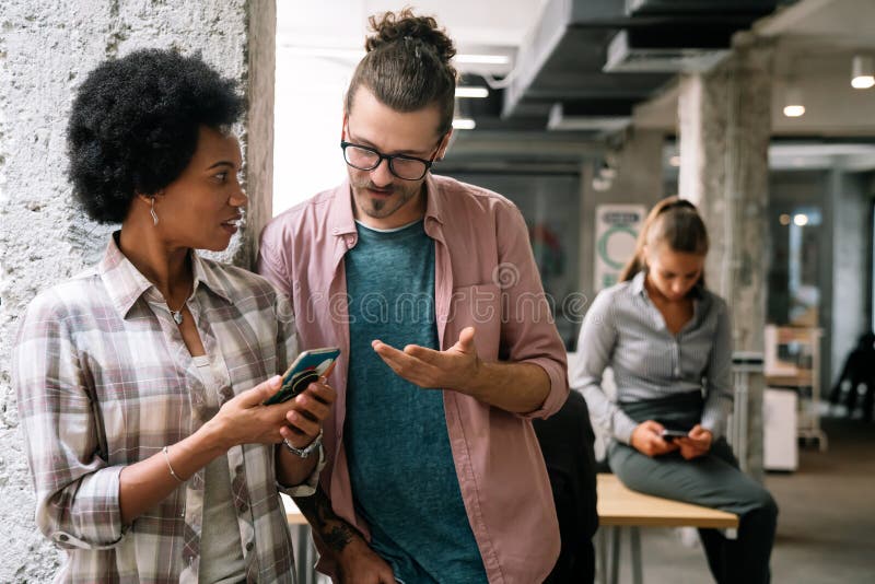 Young Startup Business People Having Fun, Working and Chatting at ...