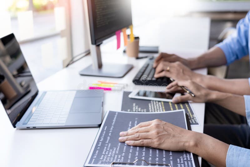 Young Startup Programmers Sitting at Desks Working on Computers Screen ...