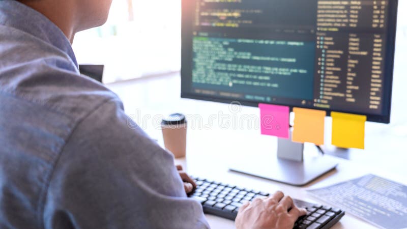 Young Startup Programmers Sitting at Desks Working on Computers Screen for Developing ...