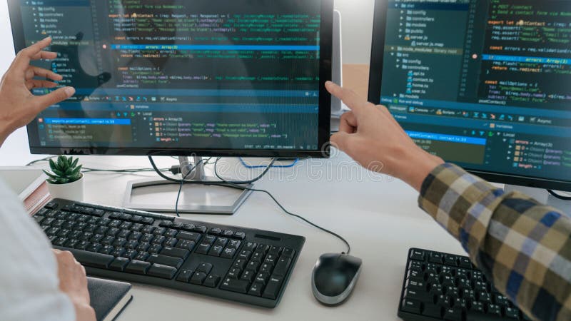 Young Startup Programmers Sitting at Desks Working on Computers Screen for Developing ...