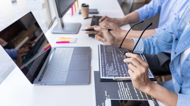 Young Startup Programmers Sitting at Desks Working on Computers Screen ...