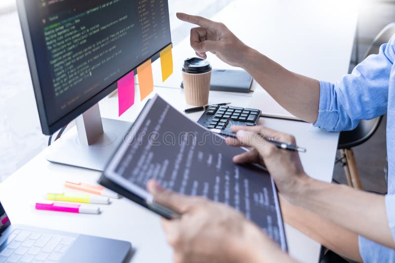 Young Startup Programmers Sitting at Desks Working on Computers Screen ...