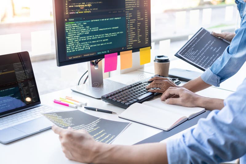 Young Startup Programmers Sitting at Desks Working on Computers Screen for Developing ...