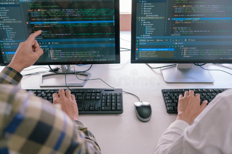 Young Startup Programmers Sitting at Desks Working on Computers Screen ...