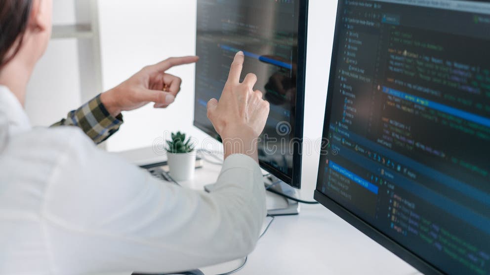 Young Startup Programmers Sitting at Desks Working on Computers Screen ...