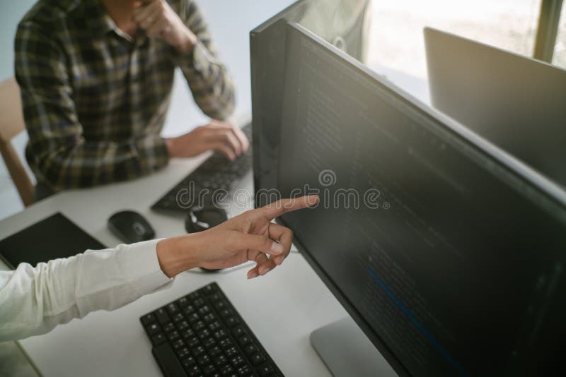 Young Startup Programmers Sitting at Desks Working on Computers Screen ...