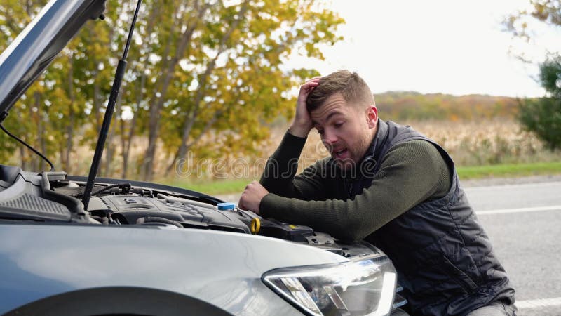 Young Stressed Man Having Trouble with His Broken Car Looking in ...
