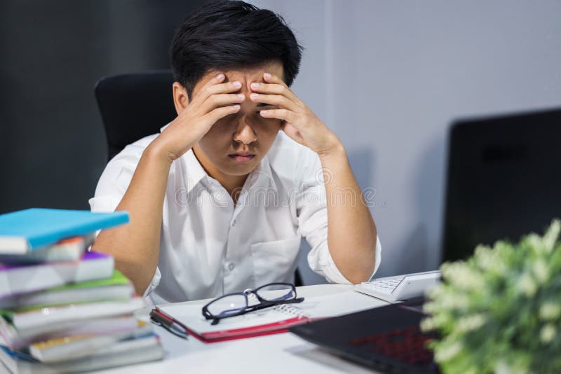 Stressed Man Studying with Book and Laptop Stock Image - Image of ...