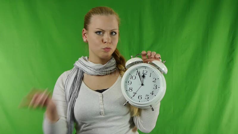 Young Strict Girl with a Alarm Clock in His Hands. Stock Footage ...