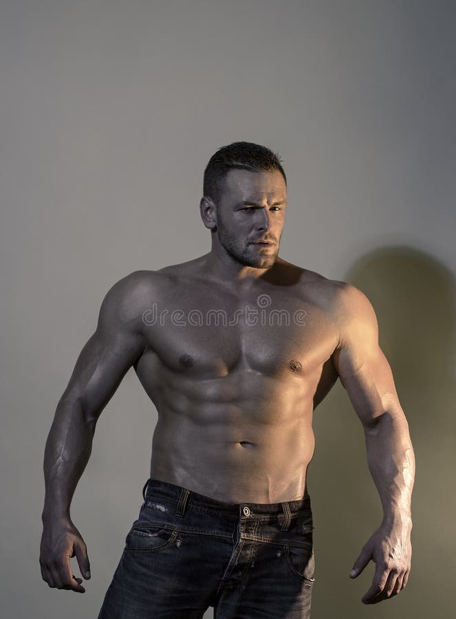 Young Strong Man Bodybuilder on Wall Background Dark Dramatic Colors ...