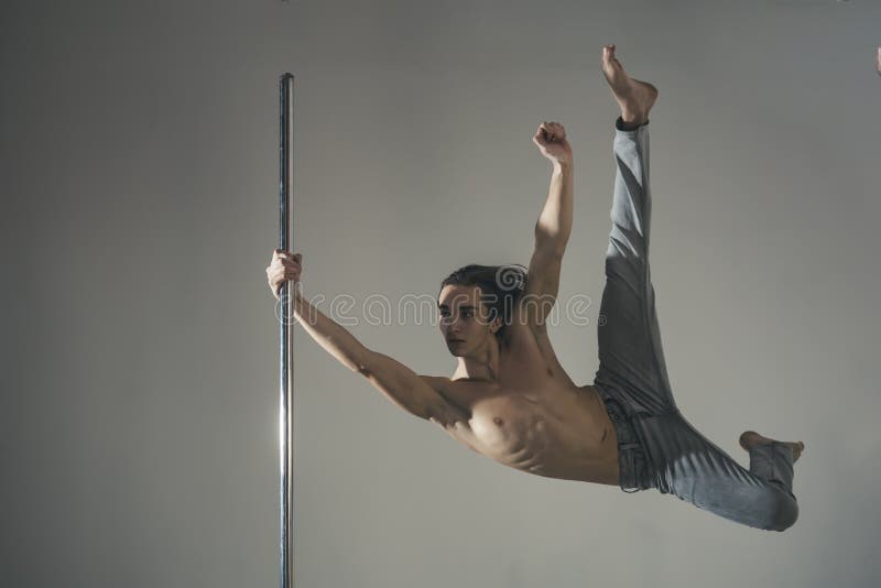 Young Strong Pole Dancer Man On Pylon Grey Background Stock Image