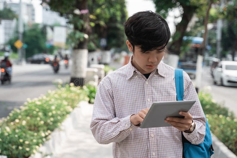 Young Student Browsing Using a Digital Tablet Stock Photo - Image of ...