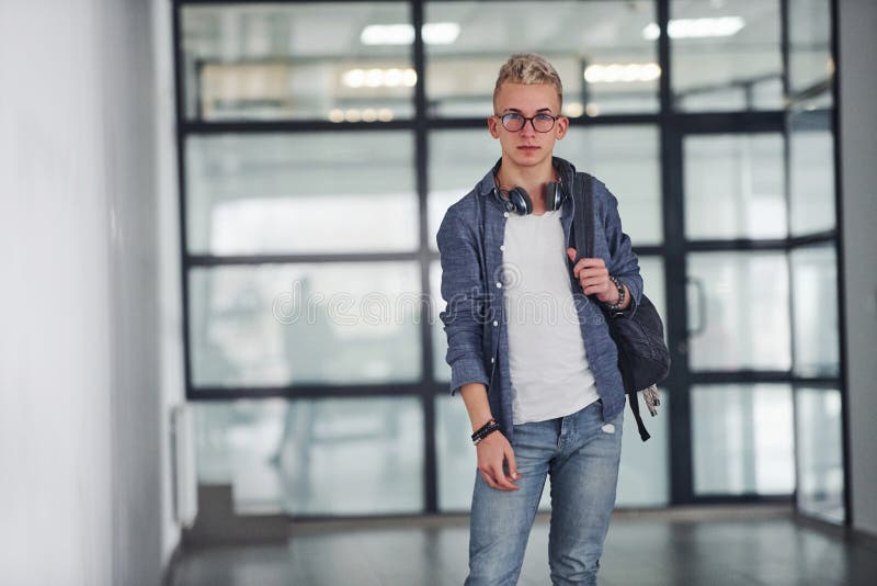 Young Student in Casual Clothes Walks Indoors with Backpack Stock Photo ...