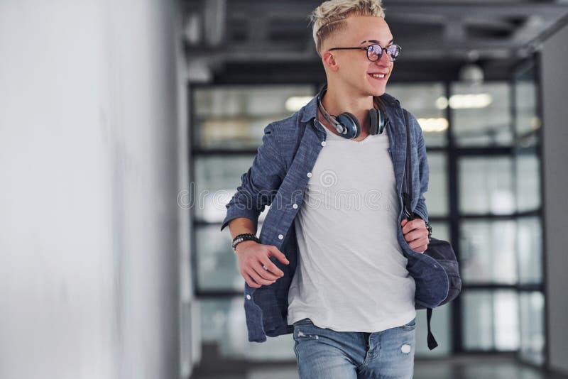 Young Student in Casual Clothes Walks Indoors with Backpack Stock Image ...