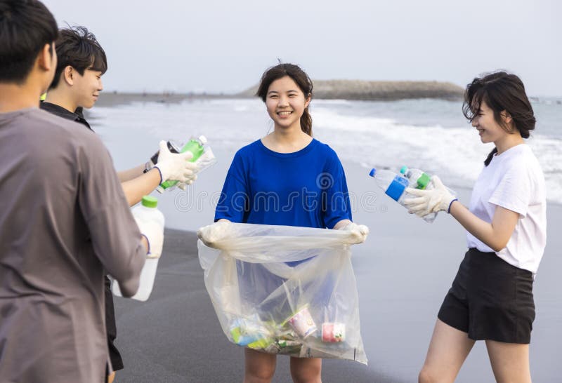 Young Student Collecting Plastic Waste on the Beach. People Cleaning ...