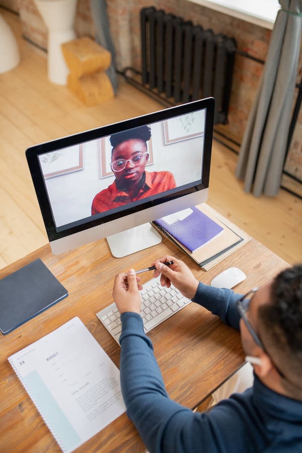 Serious Teacher in Casualwear Listening To Online Student Stock Photo ...